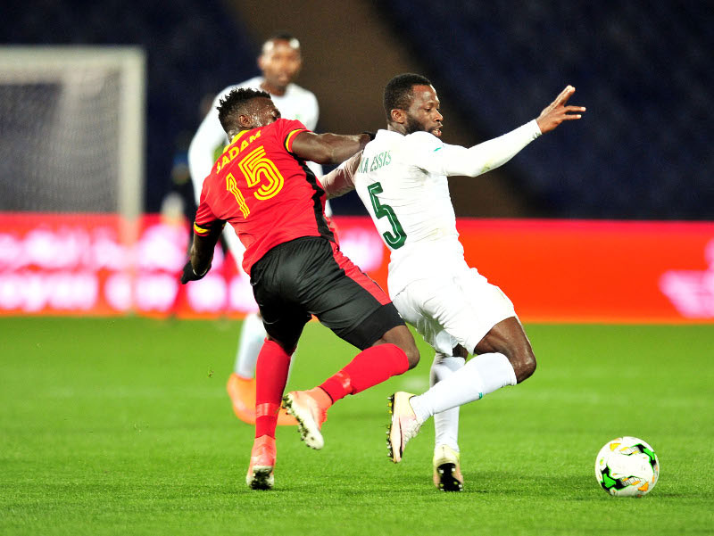 Sadam Juma tussles for the ball with an Ivorian player in the dead ...