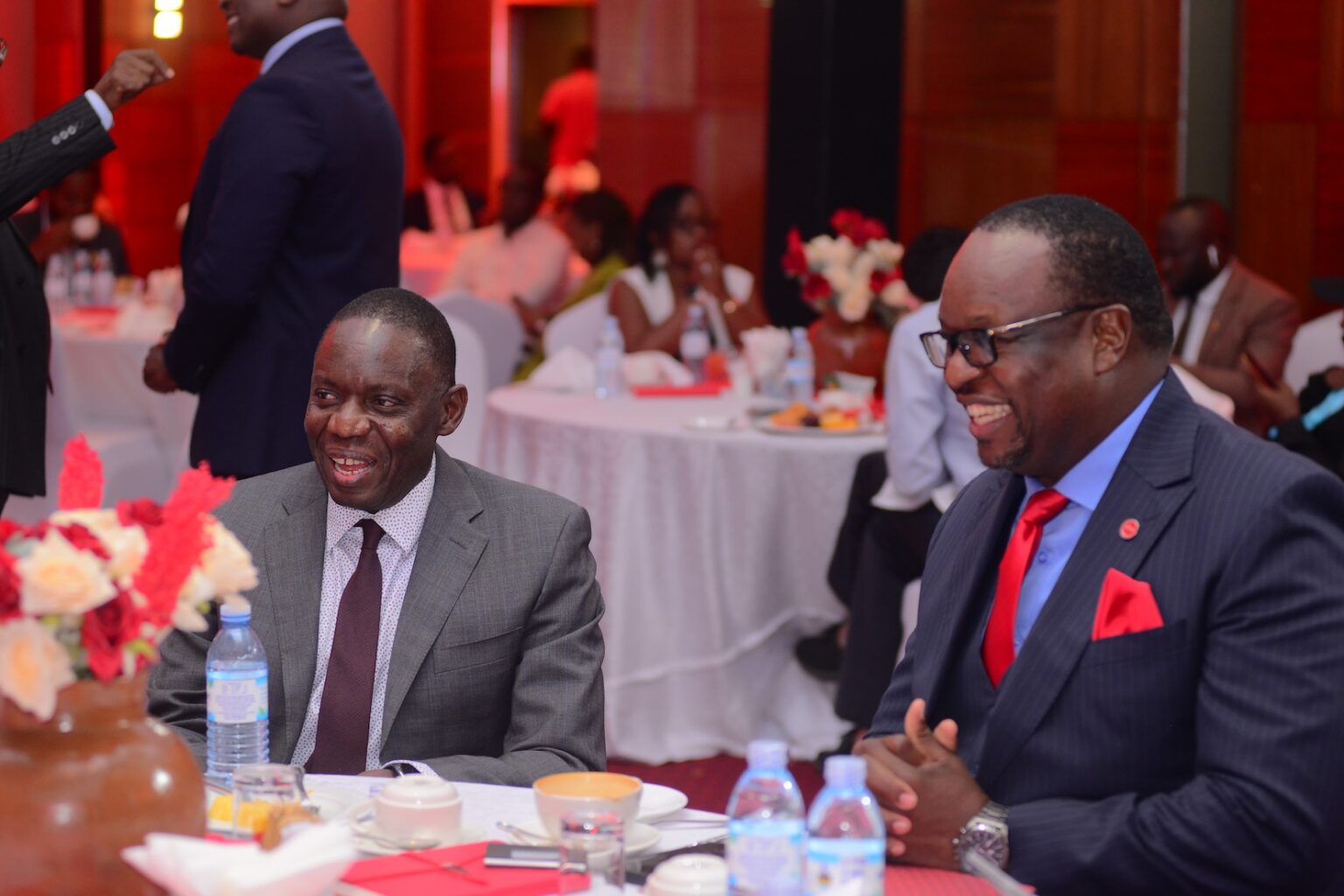 L-R) Michael Atingi-Ego – Bank of Uganda’s Deputy Governor shares a ...