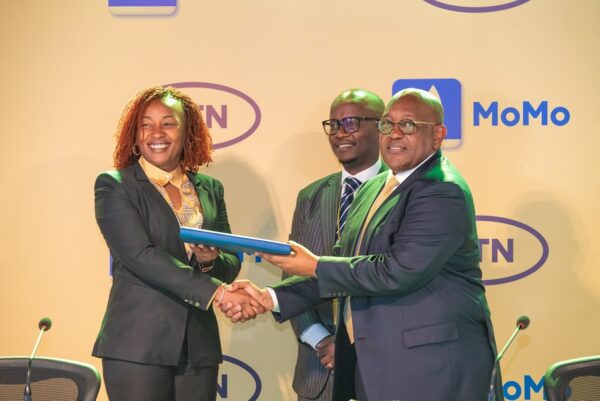 Sylvia Mulinge (left) receives instruments of power from the Chairman ...